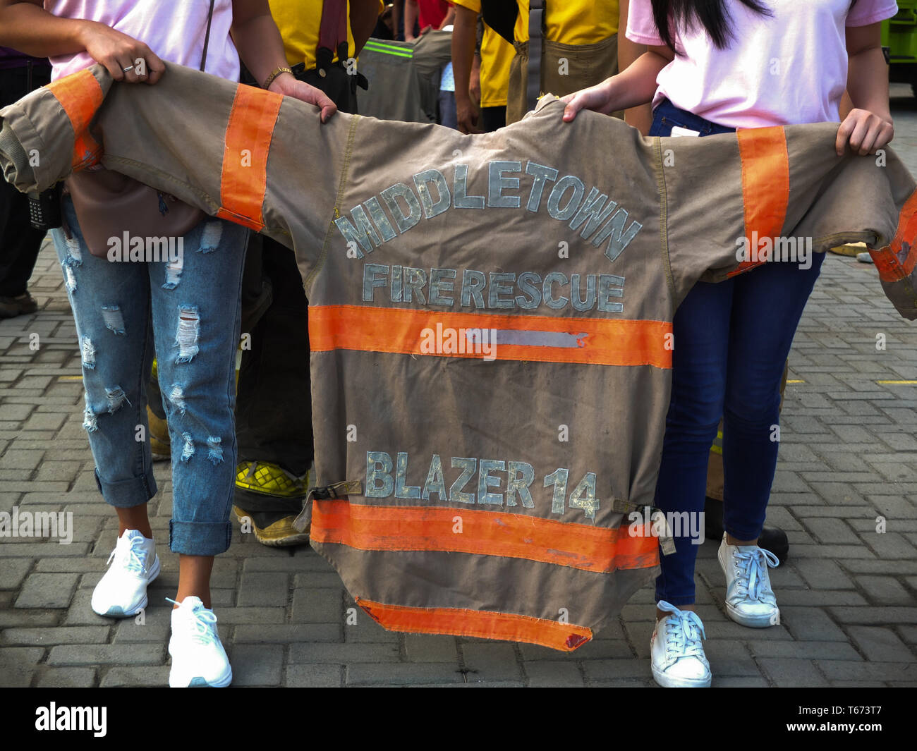 Participating fire brigade Muse seen holding a Fire brigade suit during ...