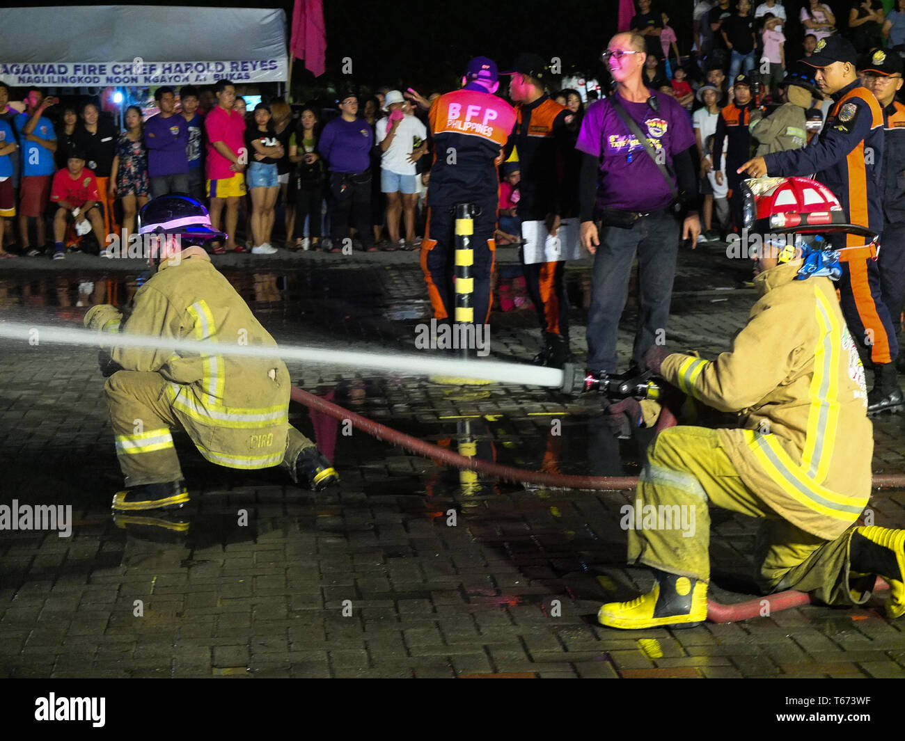 Fire fighters are seen keeping their firm hold on the nozzle because of ...