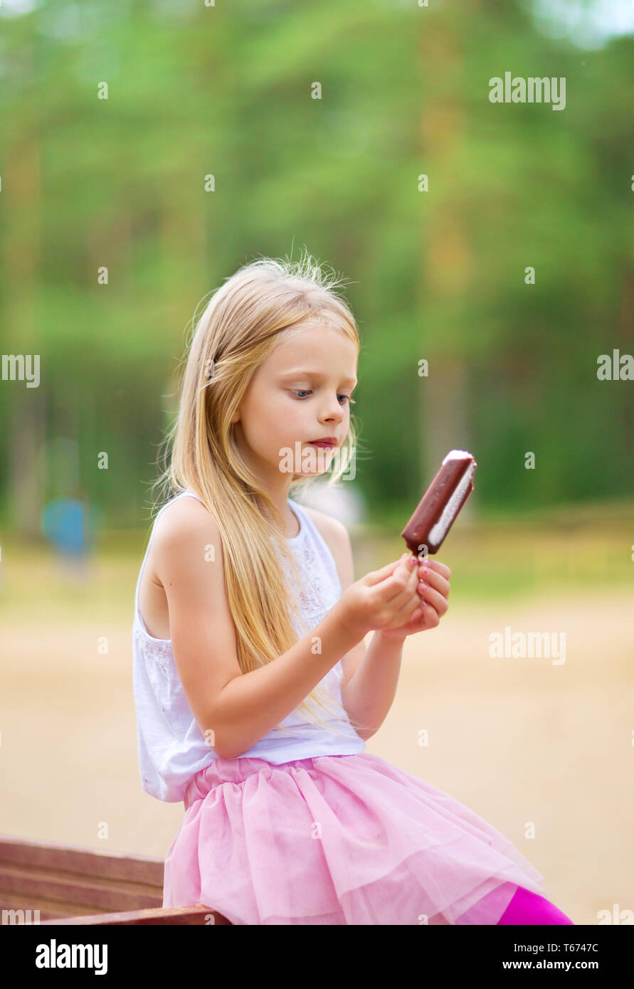 Little girl eats stick ice cream bar eskimo pie Stock Photo - Alamy
