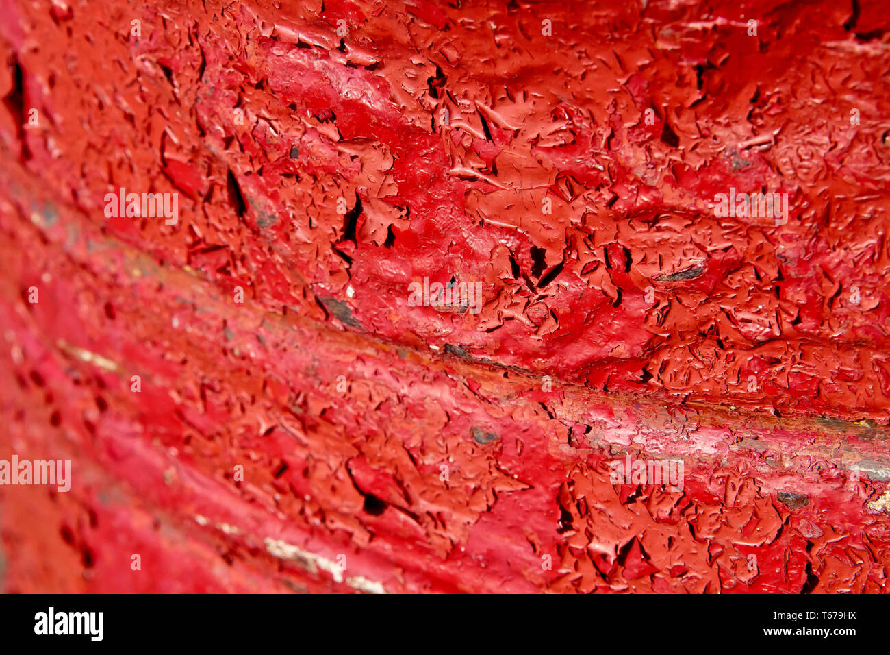 Flaking red paint on a large bollard Stock Photo - Alamy