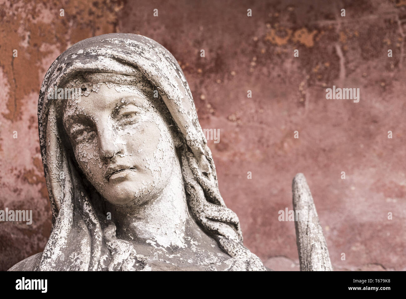 portrait of a weathered sculpture of maria with red background Stock ...