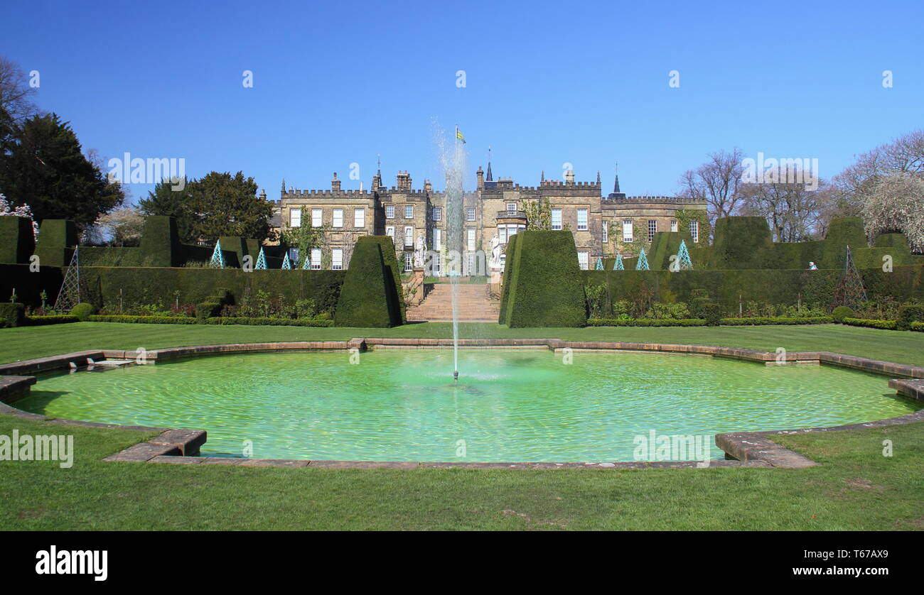 Renishaw Hall and Gardens seen from the Swimming Pool through Taxus ...
