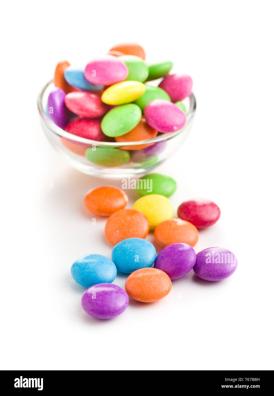 Colorful chocolate candy pills in bowl isolated on white background ...
