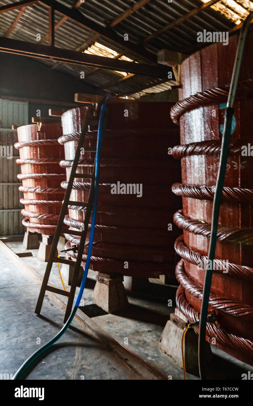 Closeup of red wooden, vats fermenting a traditional fish sauce in a ...