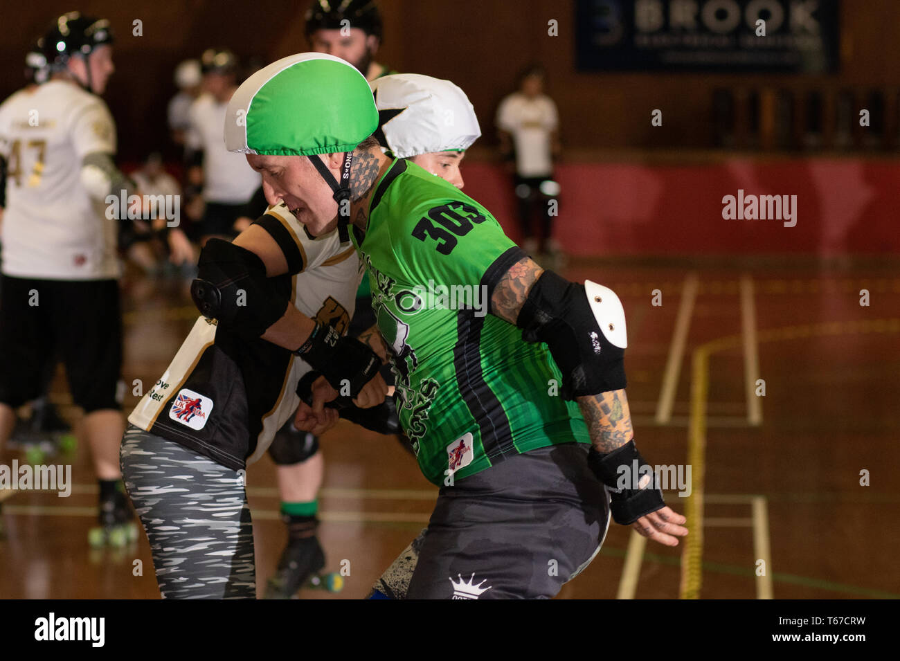 White jammer and green pivot engaged in contact Stock Photo - Alamy