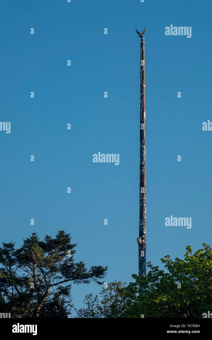 A bald eagle taking off from the Story Pole, a 39 meter totem pole in ...