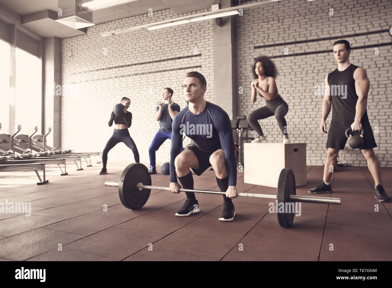 Group of athletes working out in gym Stock Photo - Alamy