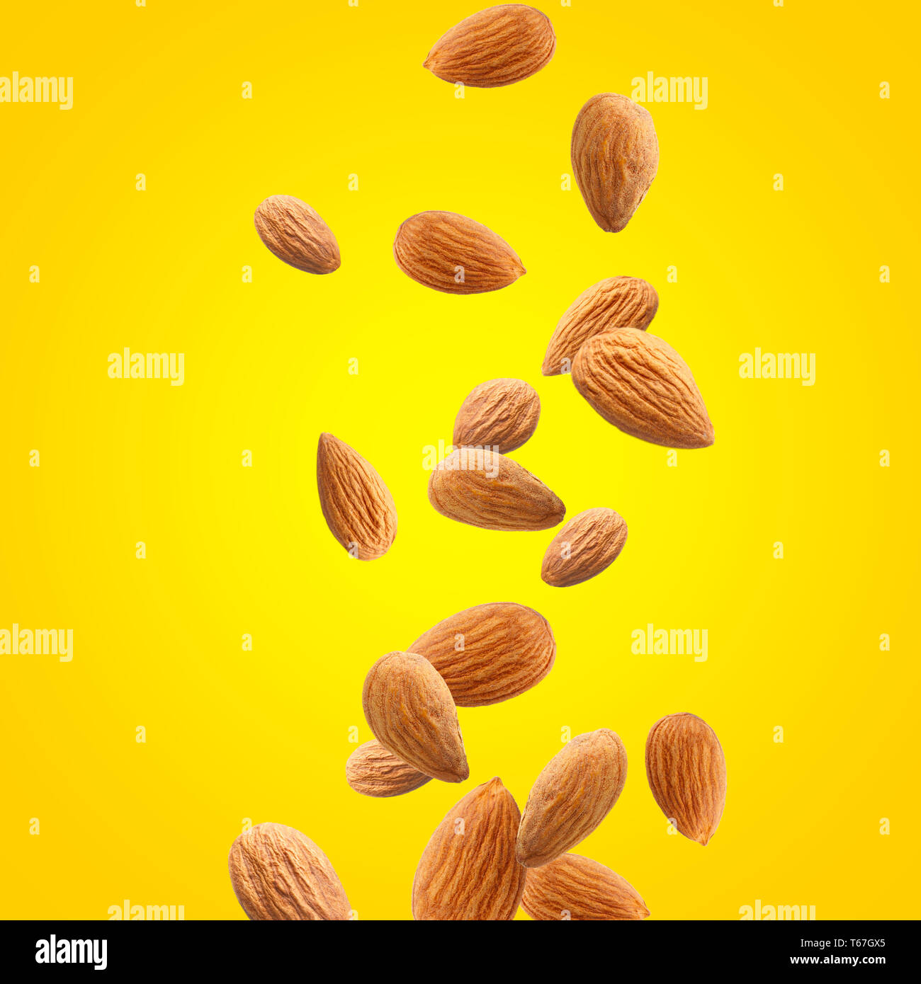 Falling almond nuts on color background Stock Photo - Alamy