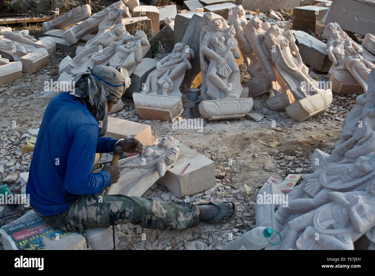 Stone carver at work + sculptures intended to embellish a jain temple ...