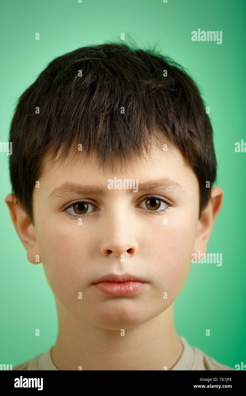 studio portrait of young boy on green background Stock Photo - Alamy