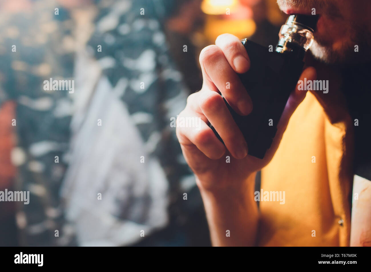 Man is smoking electronic cigarette or vaporizer Stock Photo - Alamy
