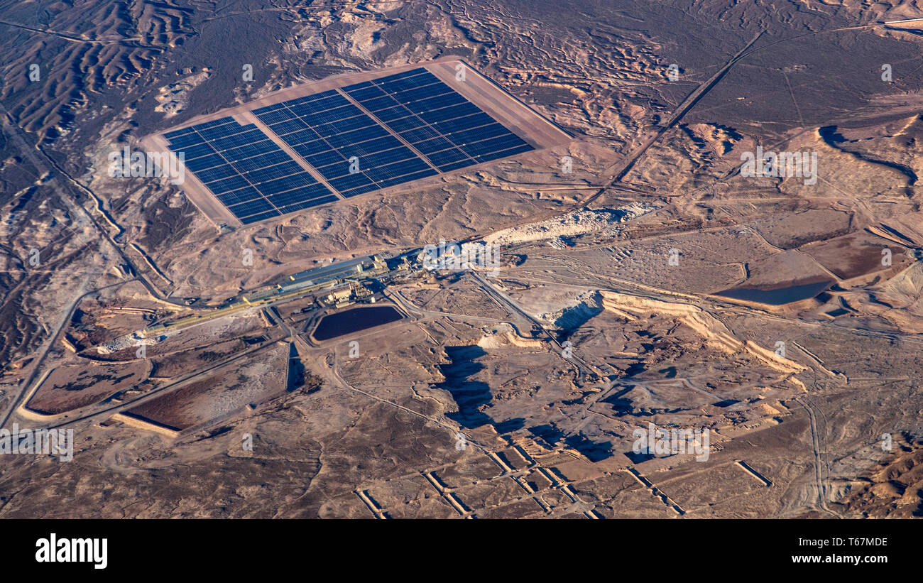A huge photo-voltaic solar power plant in the desert landscape outside ...
