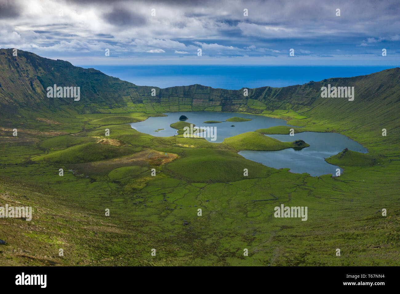Aerial view of volcanic crater (Caldeirao) with a beautiful lake on the ...