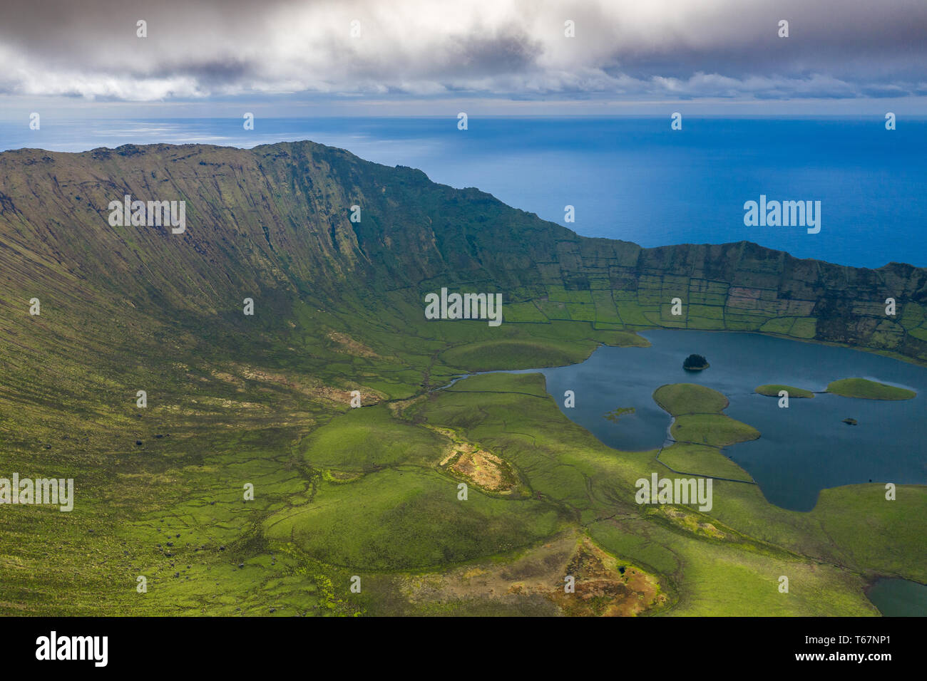 Aerial view of volcanic crater (Caldeirao) with a beautiful lake on the ...