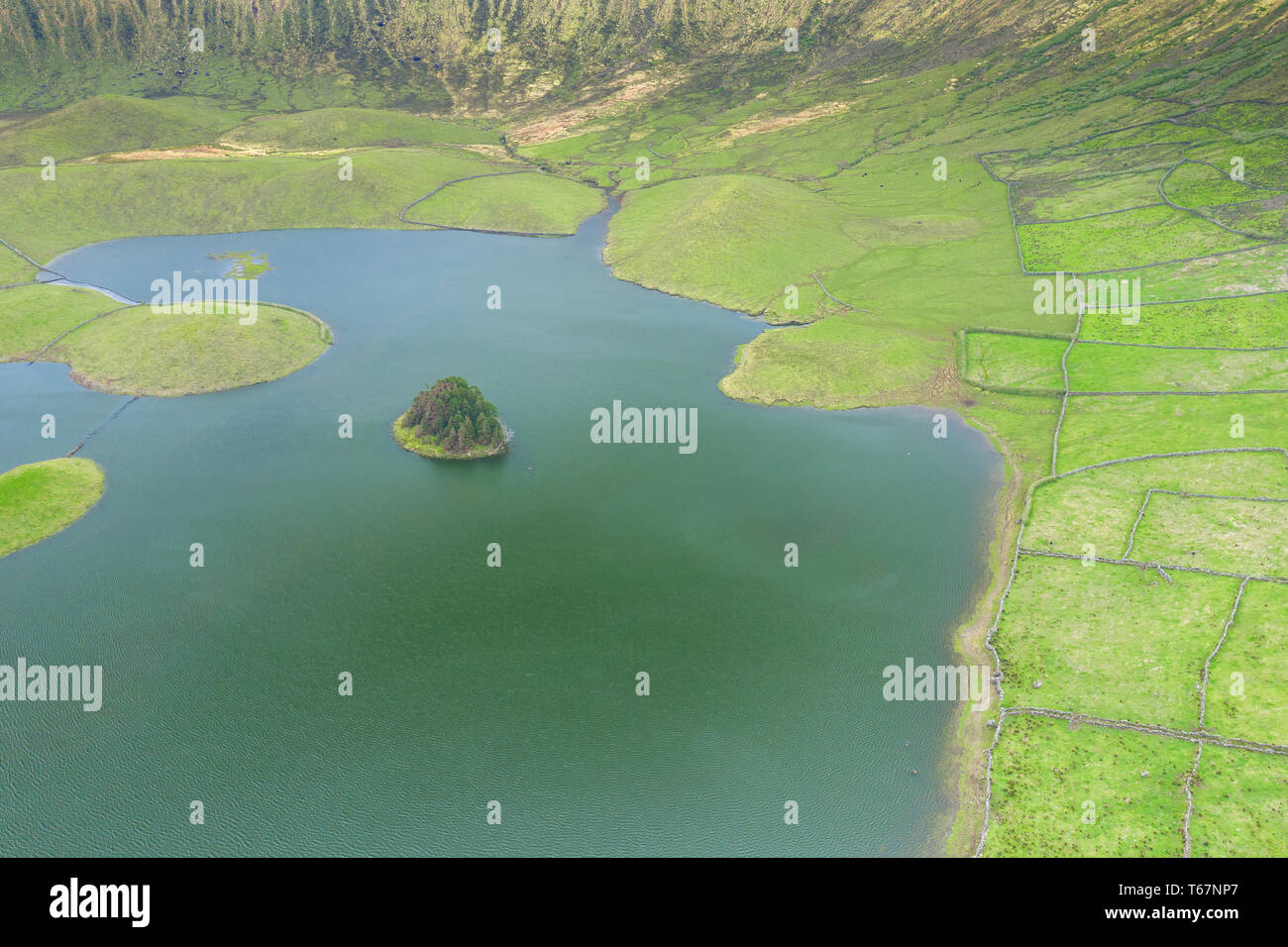 Aerial view of volcanic crater (Caldeirao) with a beautiful lake on the ...