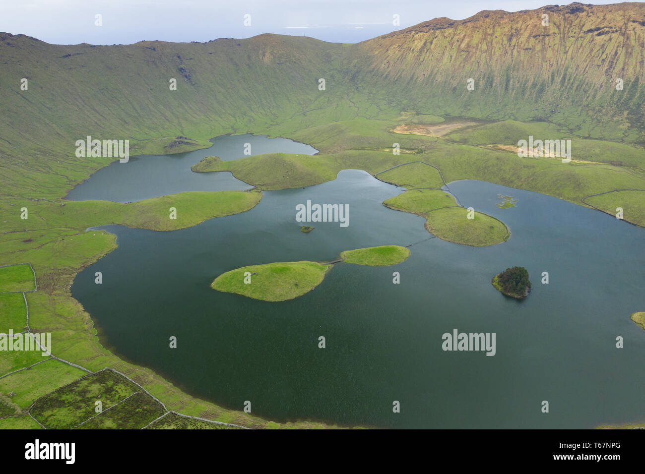 Aerial view of volcanic crater (Caldeirao) with a beautiful lake on the ...