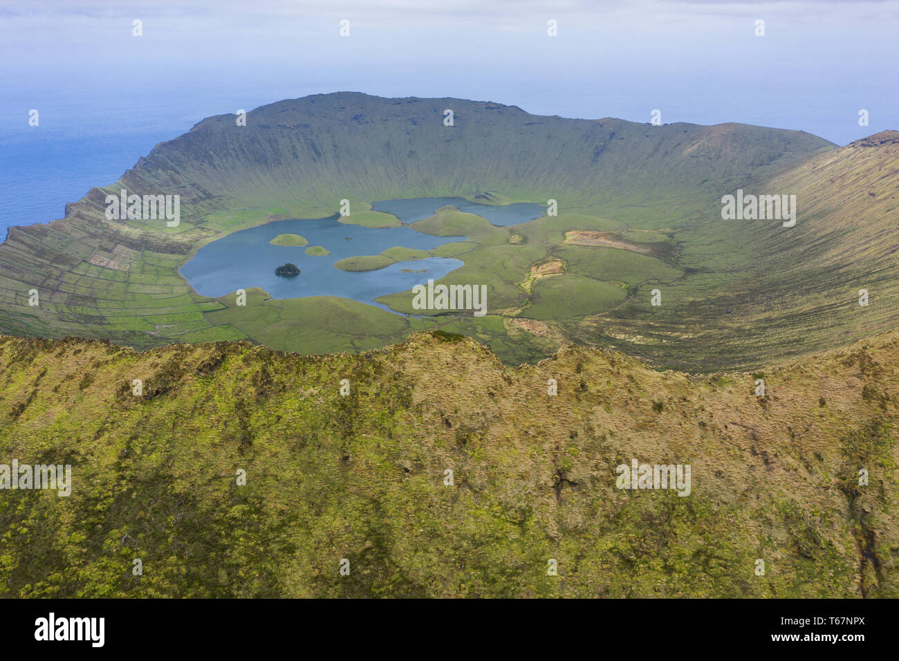 Aerial view of volcanic crater (Caldeirao) with a beautiful lake on the ...