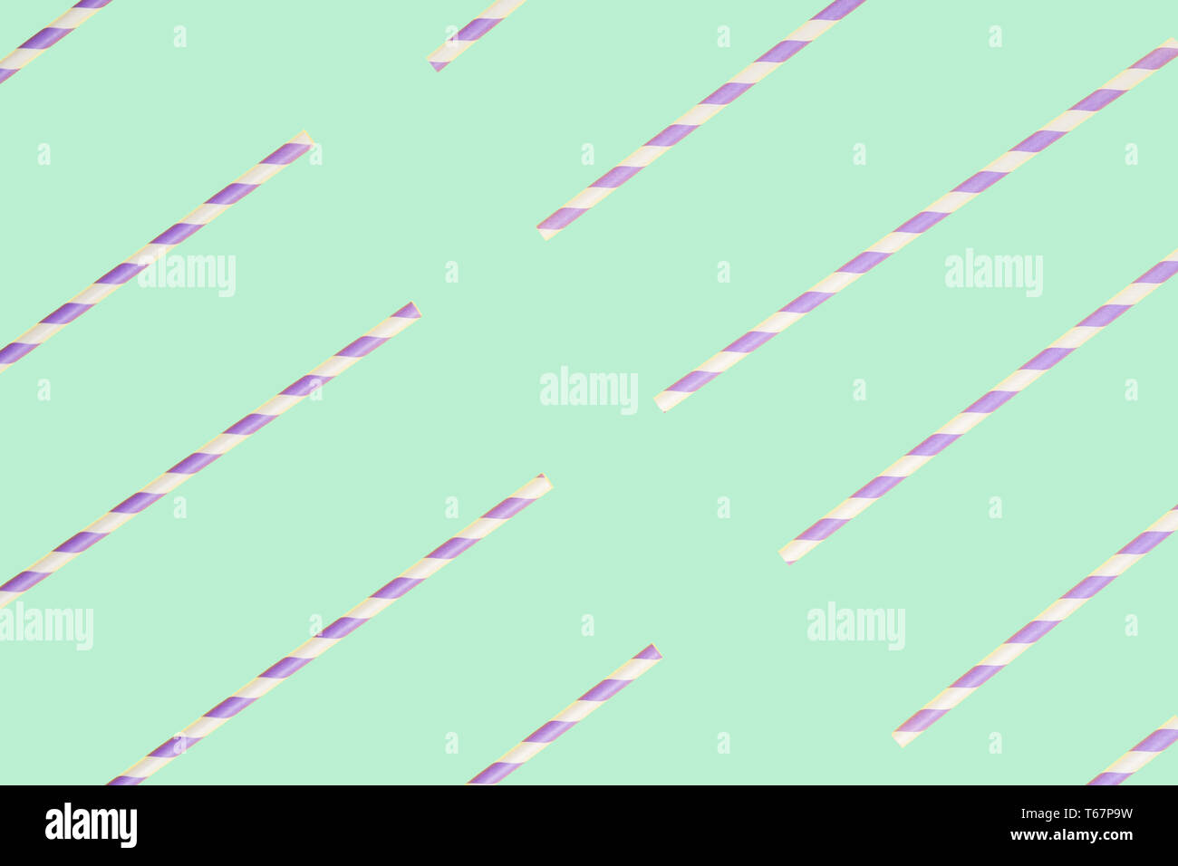 Purple paper straws on mint green color background. Pattern Stock Photo ...
