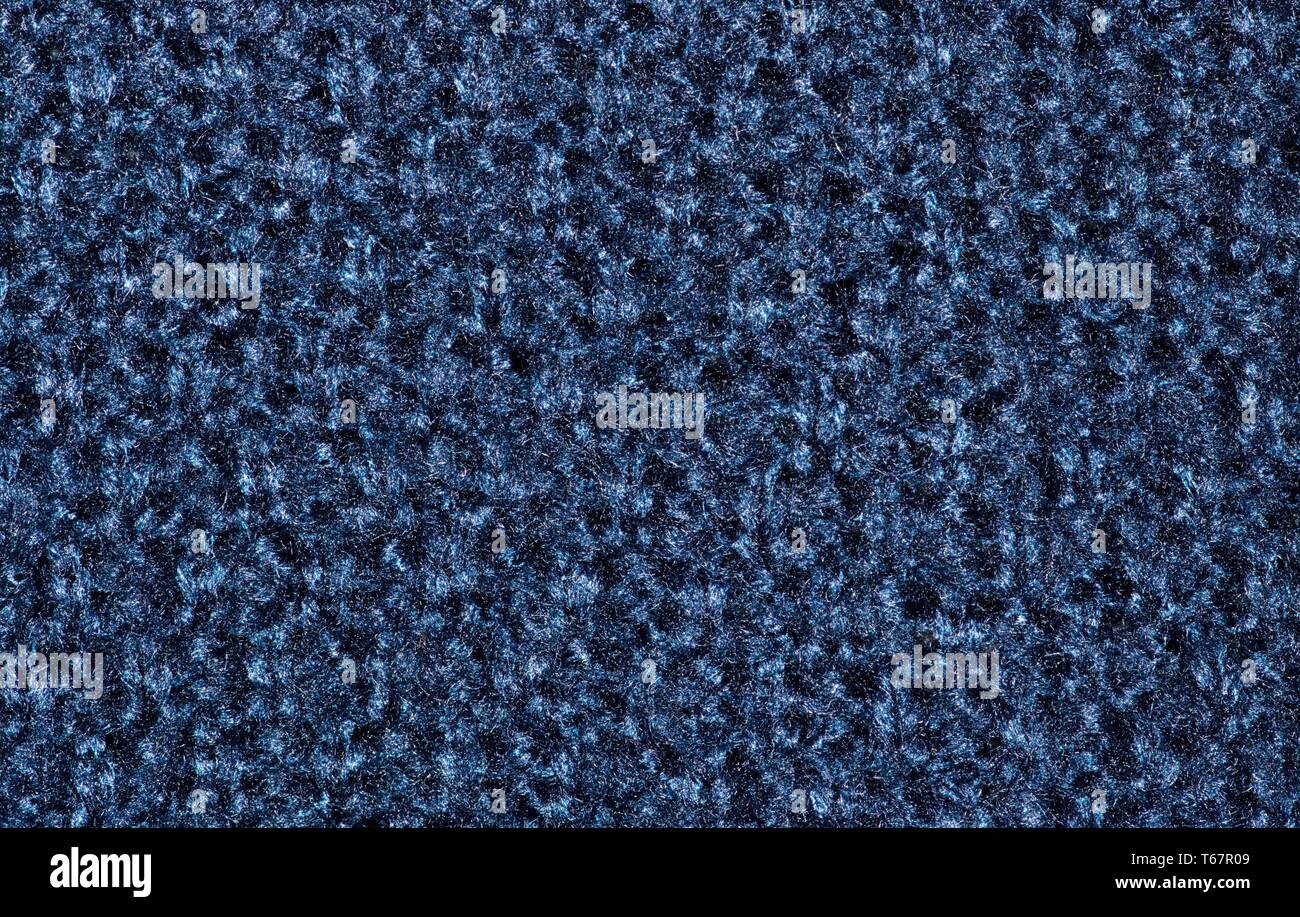 Macro color swatch of a blue woolen cardigan detailing the fine ...