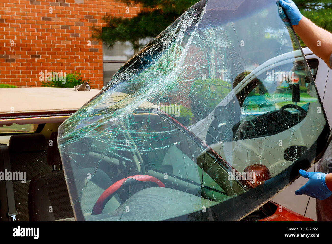 Broken windshield car special workers take of windshield of a car in ...