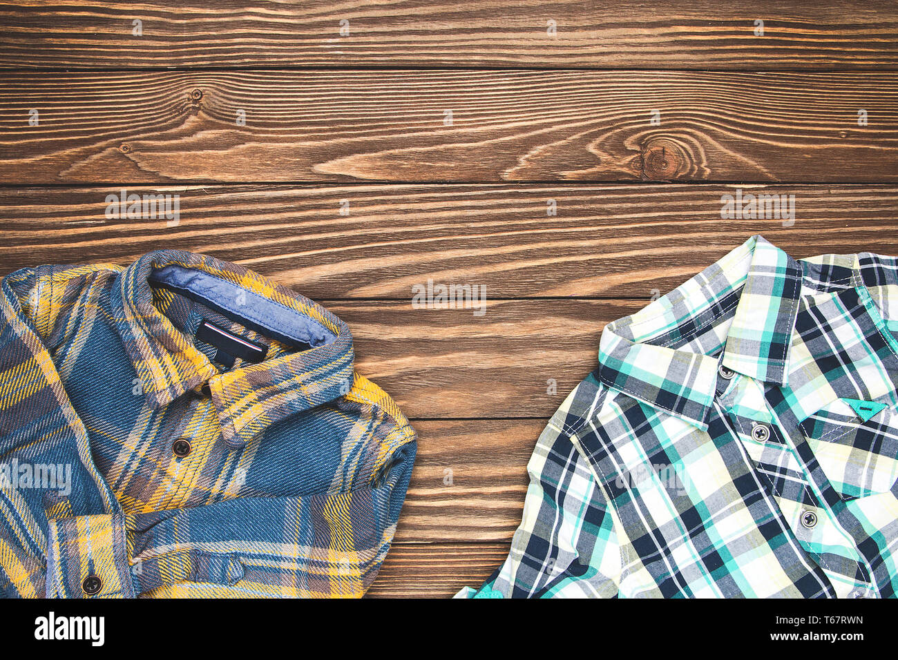 Set of children's clothes for the boy. Two shirts on wooden background ...