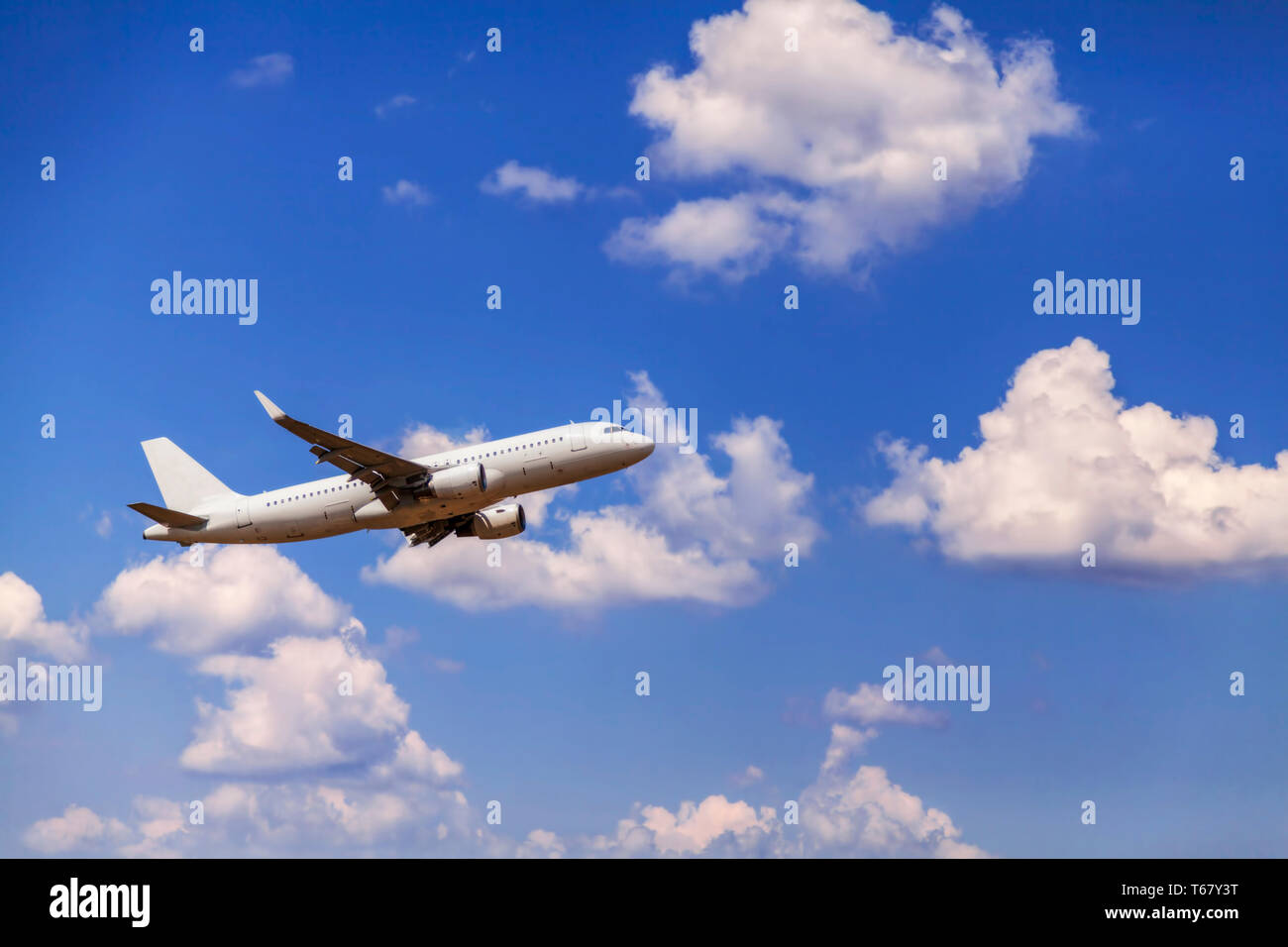 White passenger commercial plane in flight. The aircraft flies airplane ...