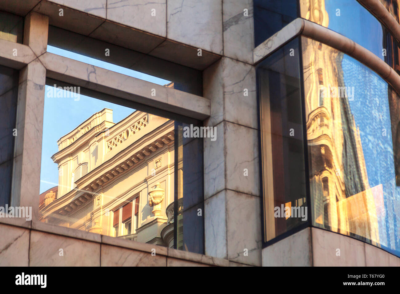 Classic architecture building reflected distorted in a modern building ...