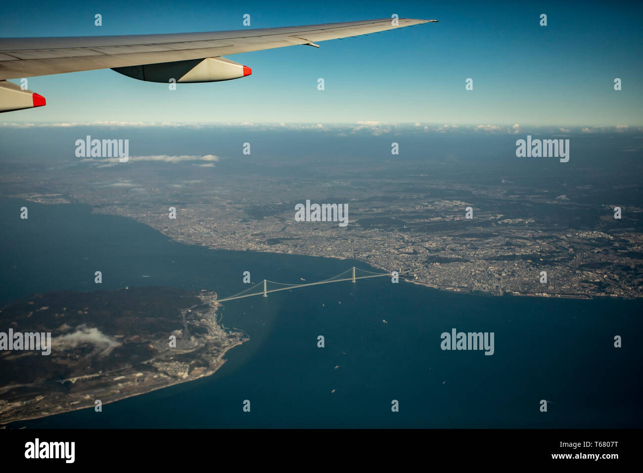 aerial view from plane window over Akashi-Kaikyo Bridge crossing osaka ...