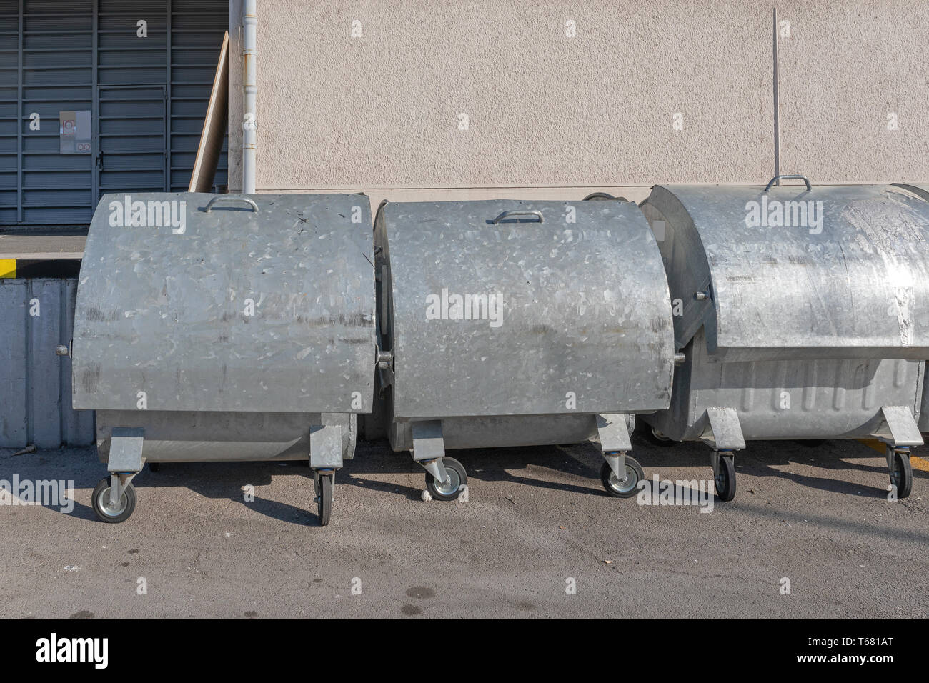 Big Metal Industrial Waste Containers With Wheels Stock Photo - Alamy