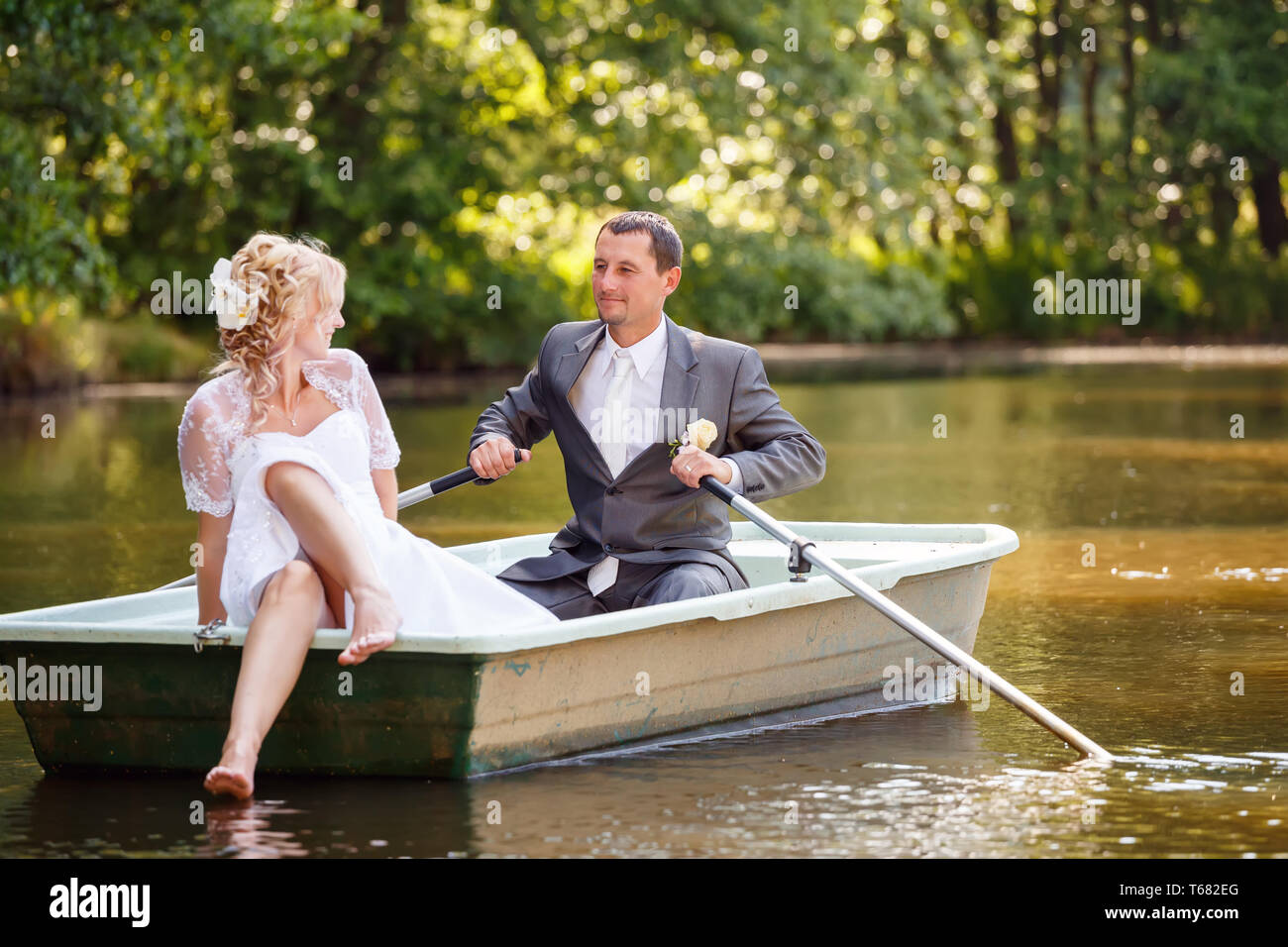 Young just married bride and groom on boat Stock Photo - Alamy