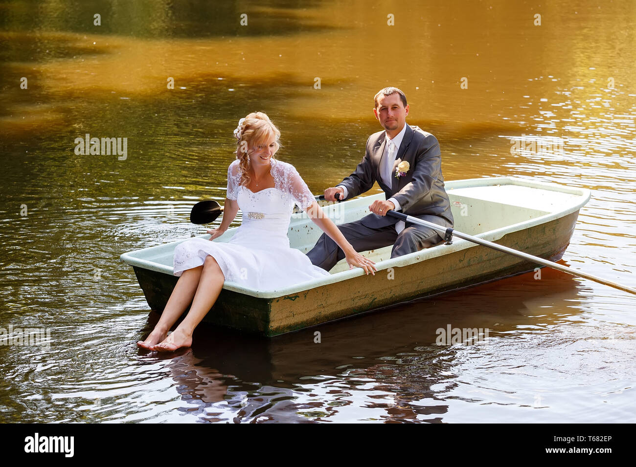 Young just married bride and groom on boat Stock Photo - Alamy