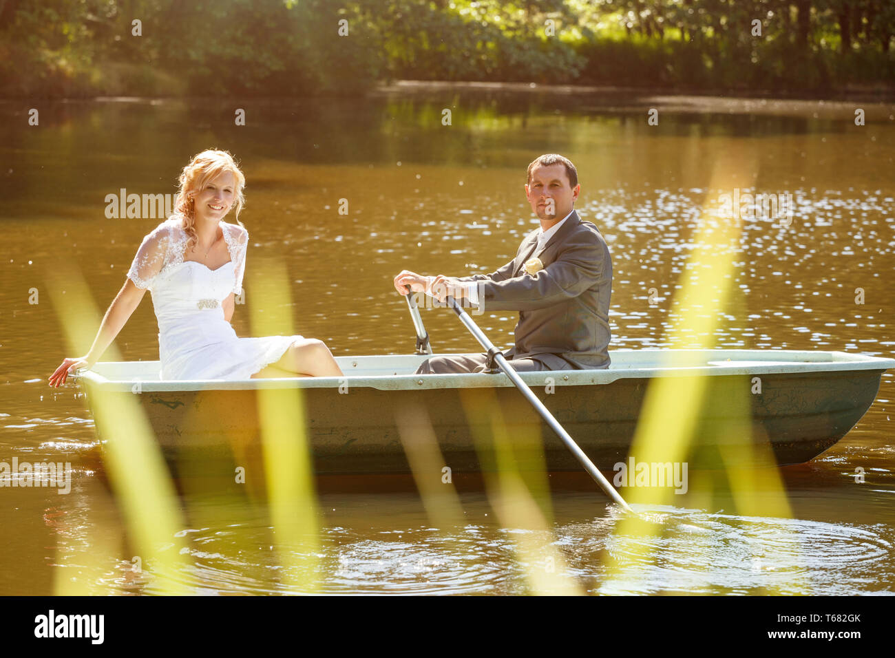 Young just married bride and groom on boat Stock Photo - Alamy