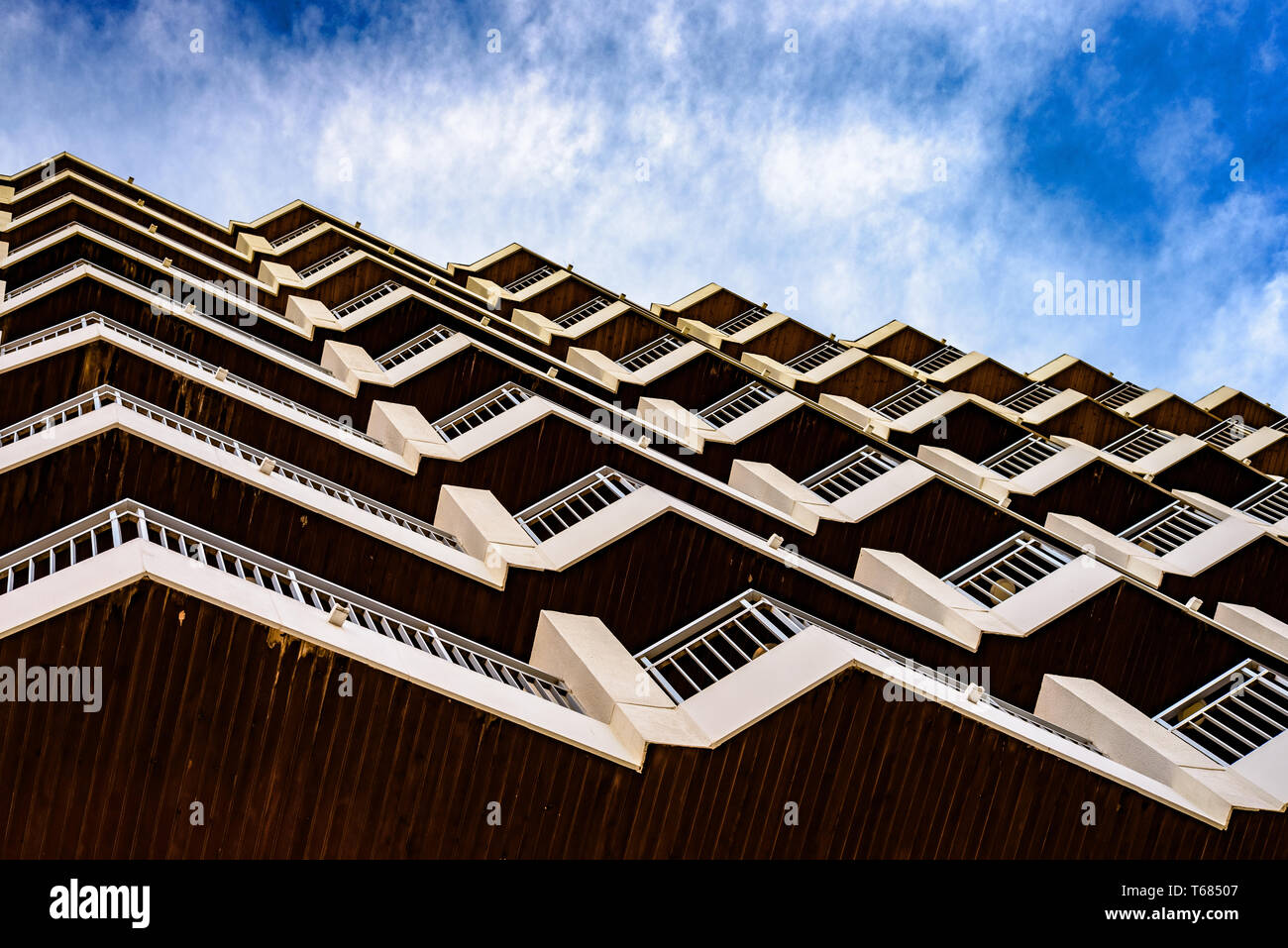 Residential building of symmetrical architectural patterns with blue ...