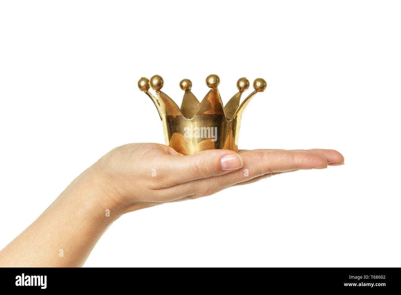 Female hand holding golden crown Stock Photo - Alamy