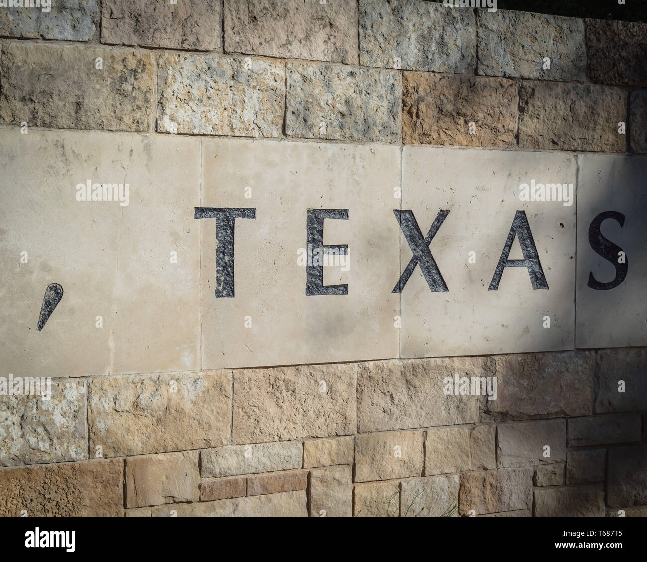 Old stone texture of Texas with a comma word on wall brick Stock Photo ...