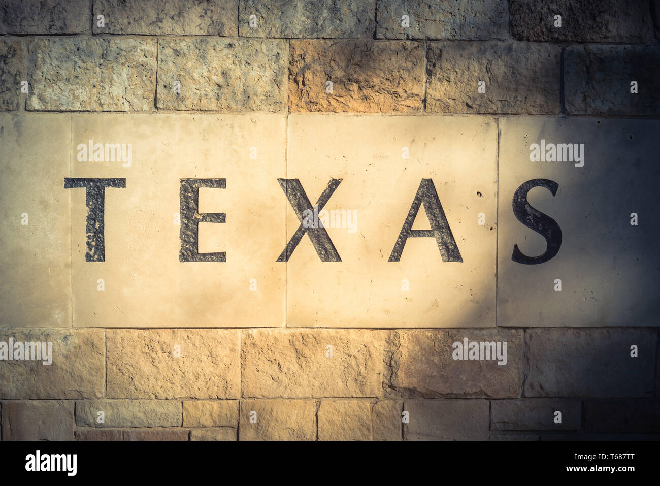 Old stone texture of Texas word on wall brick Stock Photo - Alamy