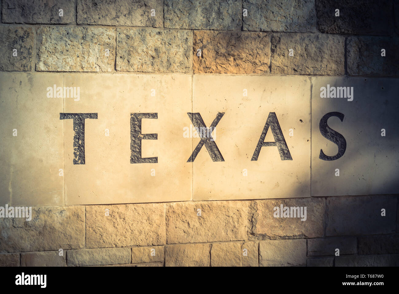 Old stone texture of Texas word on wall brick Stock Photo - Alamy