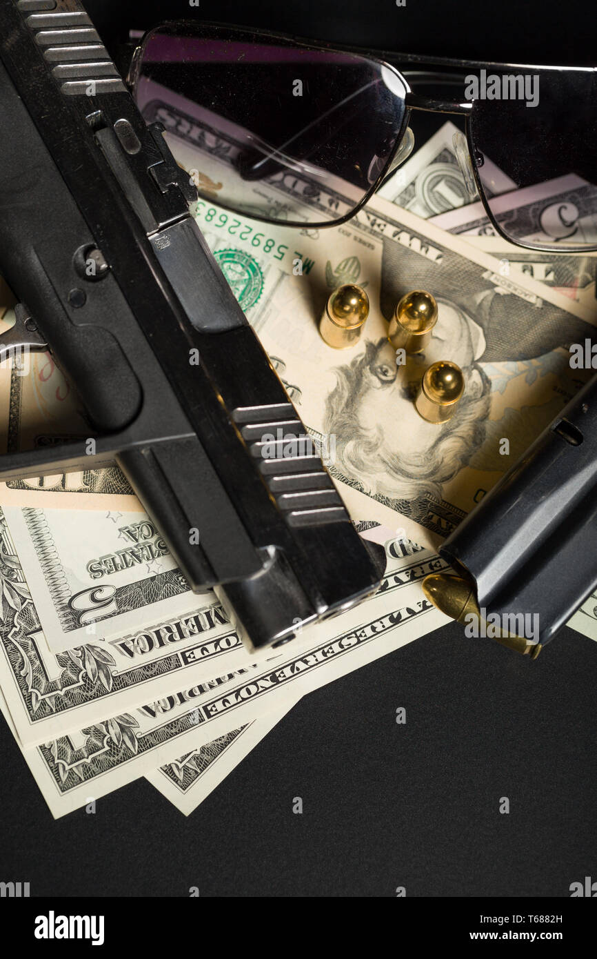gun with bullet on US dollar banknotes Stock Photo - Alamy