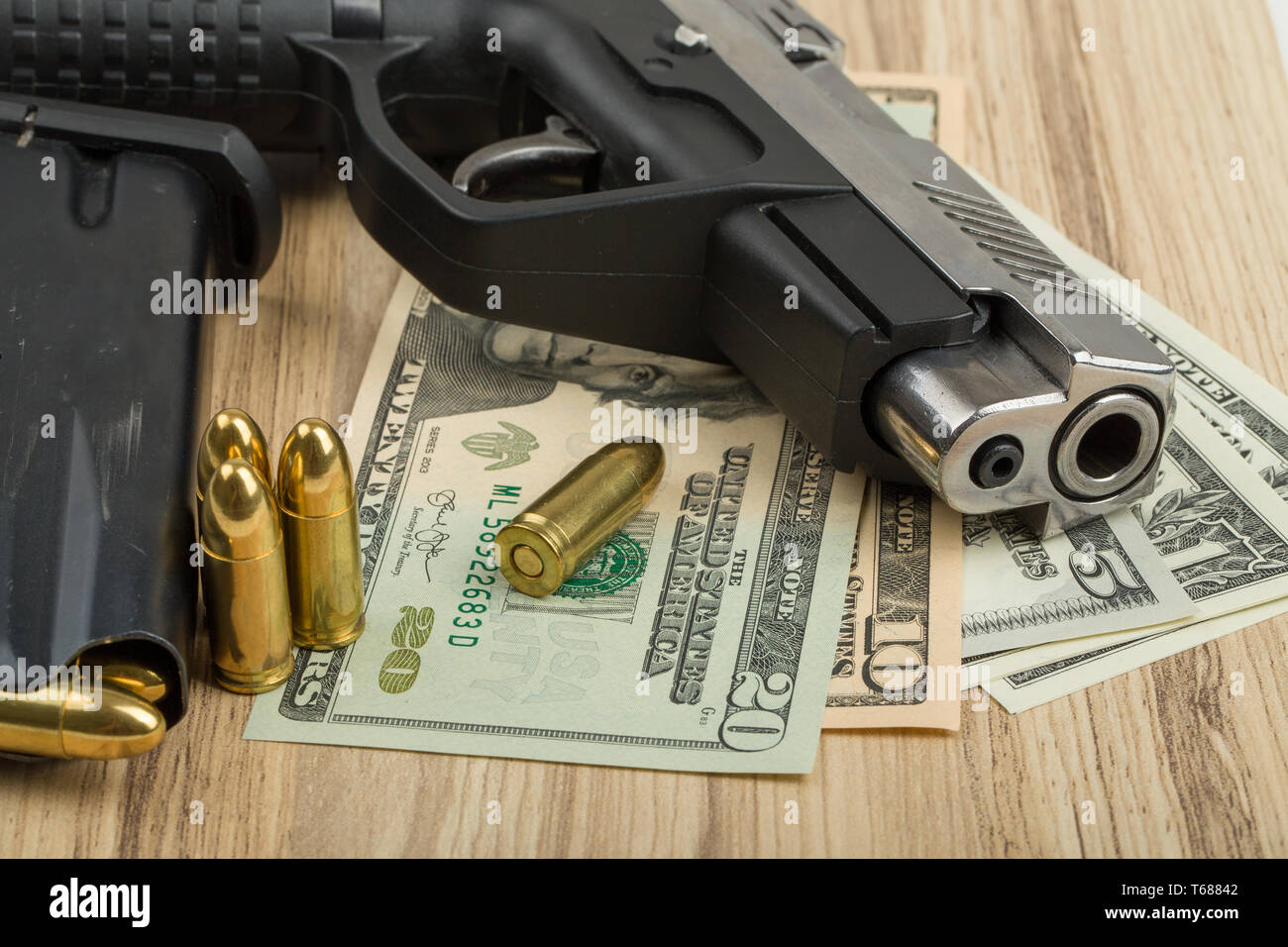 gun with bullet on US dollar banknotes Stock Photo - Alamy