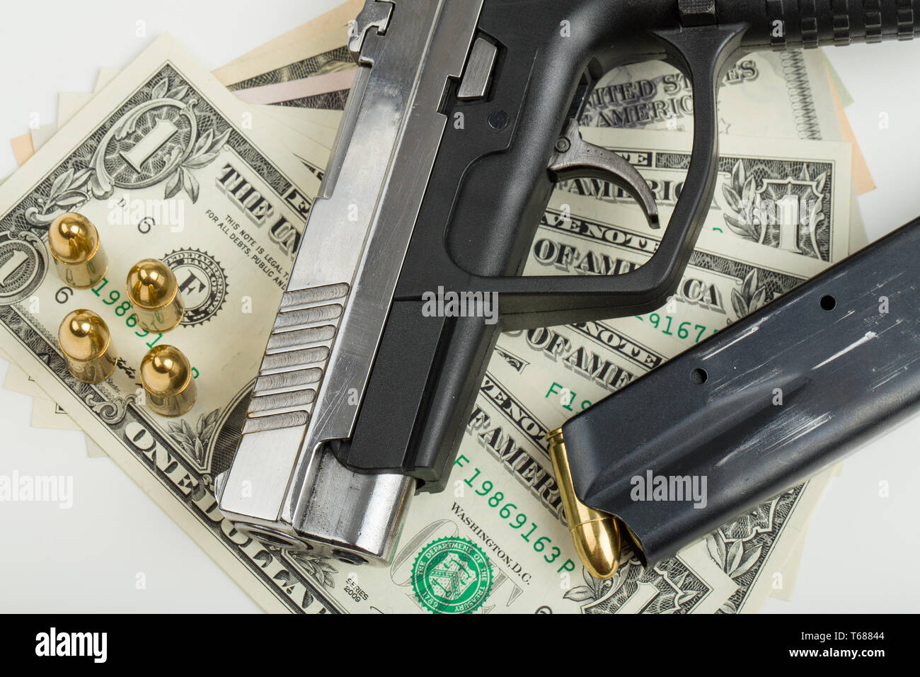 gun with bullet on US dollar banknotes Stock Photo - Alamy