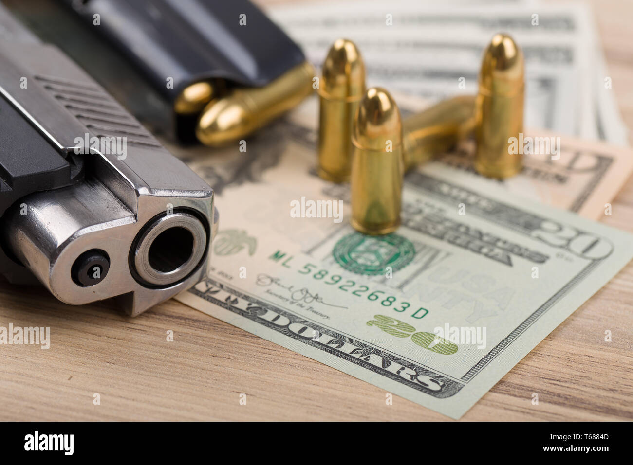 gun with bullet on US dollar banknotes Stock Photo - Alamy