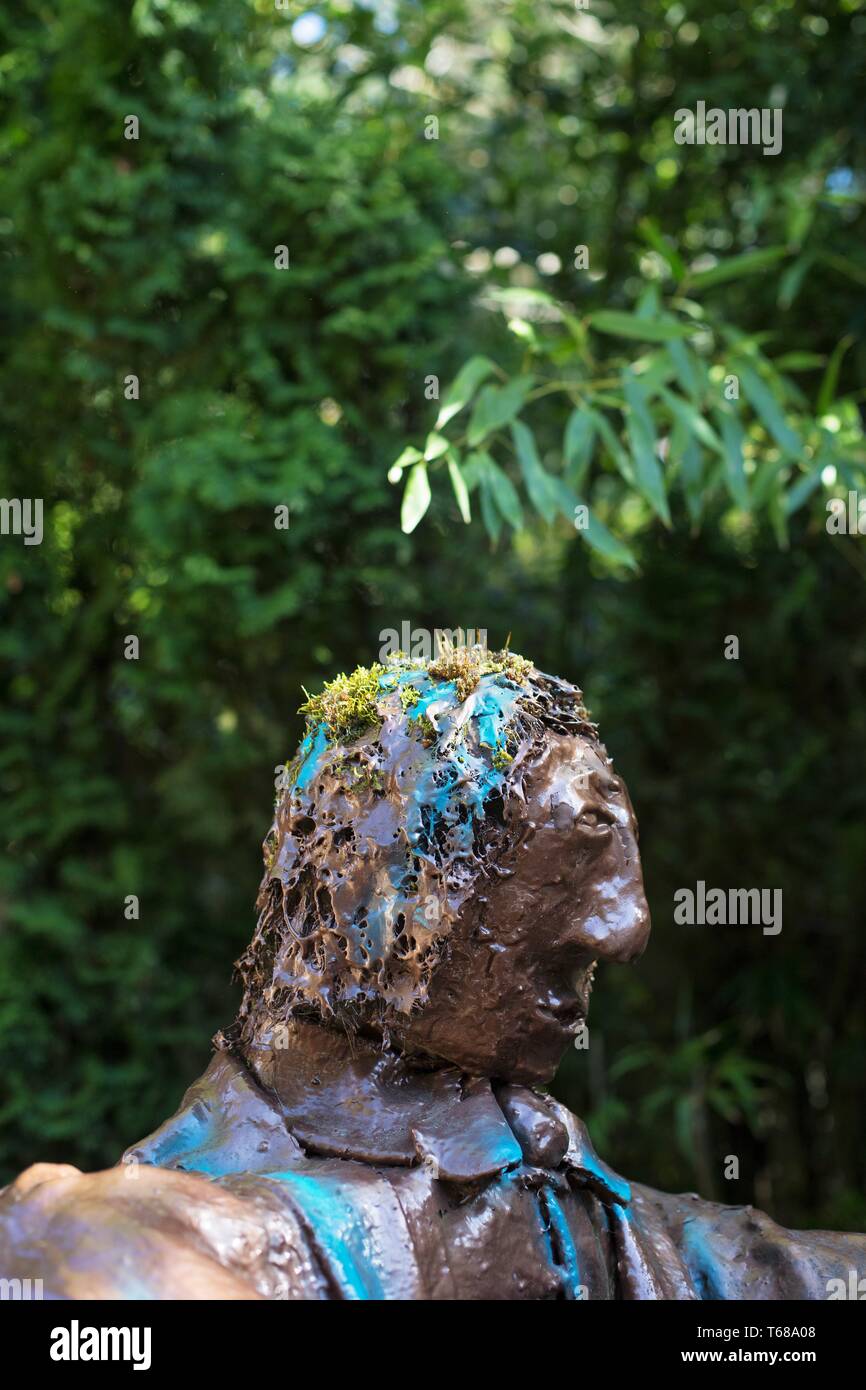 A sculpture of a man with moss growing on his head, at Belknap Hot ...