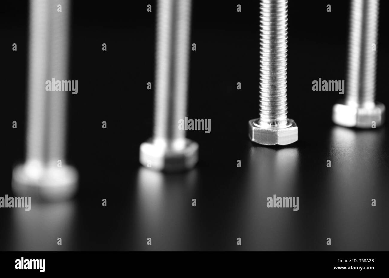 Stack of shiny bolt on a black background Stock Photo - Alamy