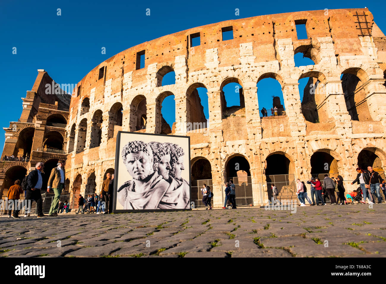 Tourists outside the Colosseum or Coliseum, the most famous landmark ...