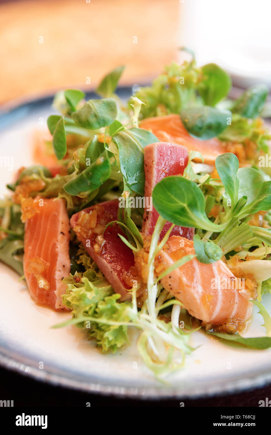 Appetizer with rare fried tuna and salmon, asian style Stock Photo - Alamy