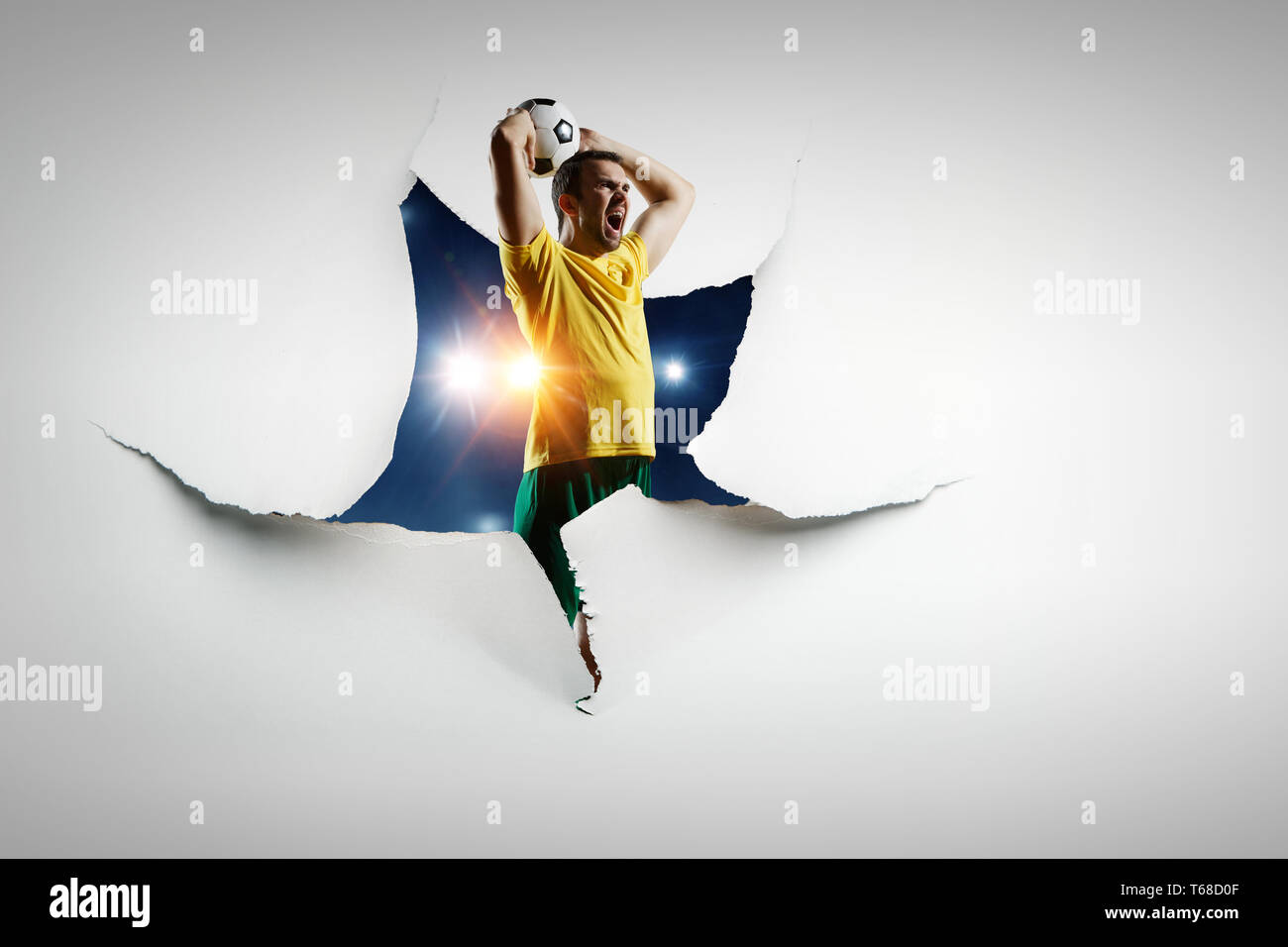 Paper breakthrough hole effect and soccer player. Mixed media Stock ...