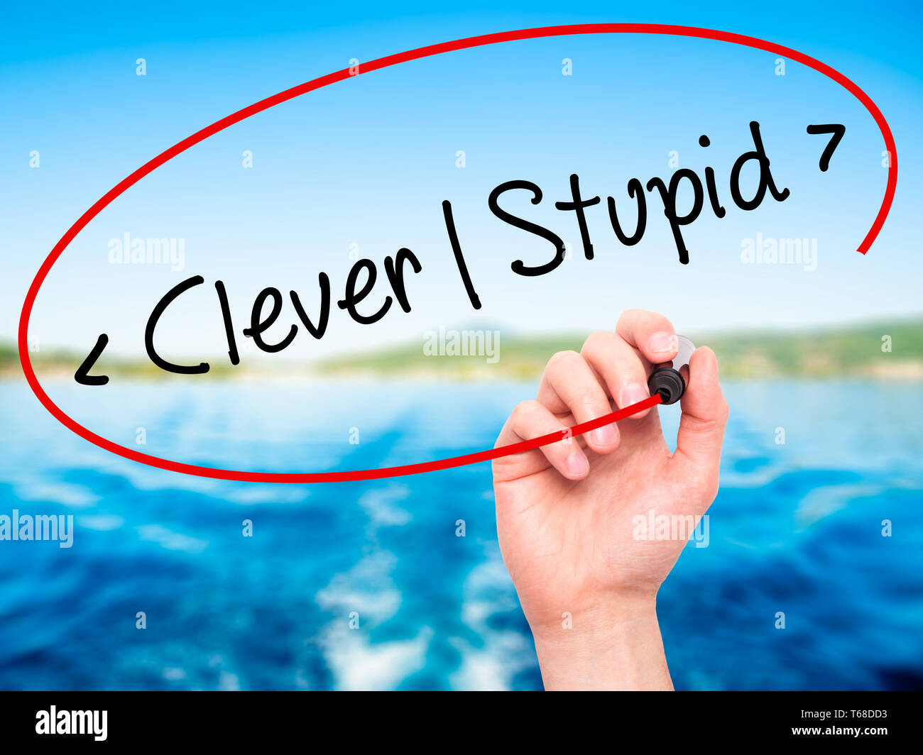 Man Hand writing Clever - Stupid with black marker on visual screen ...