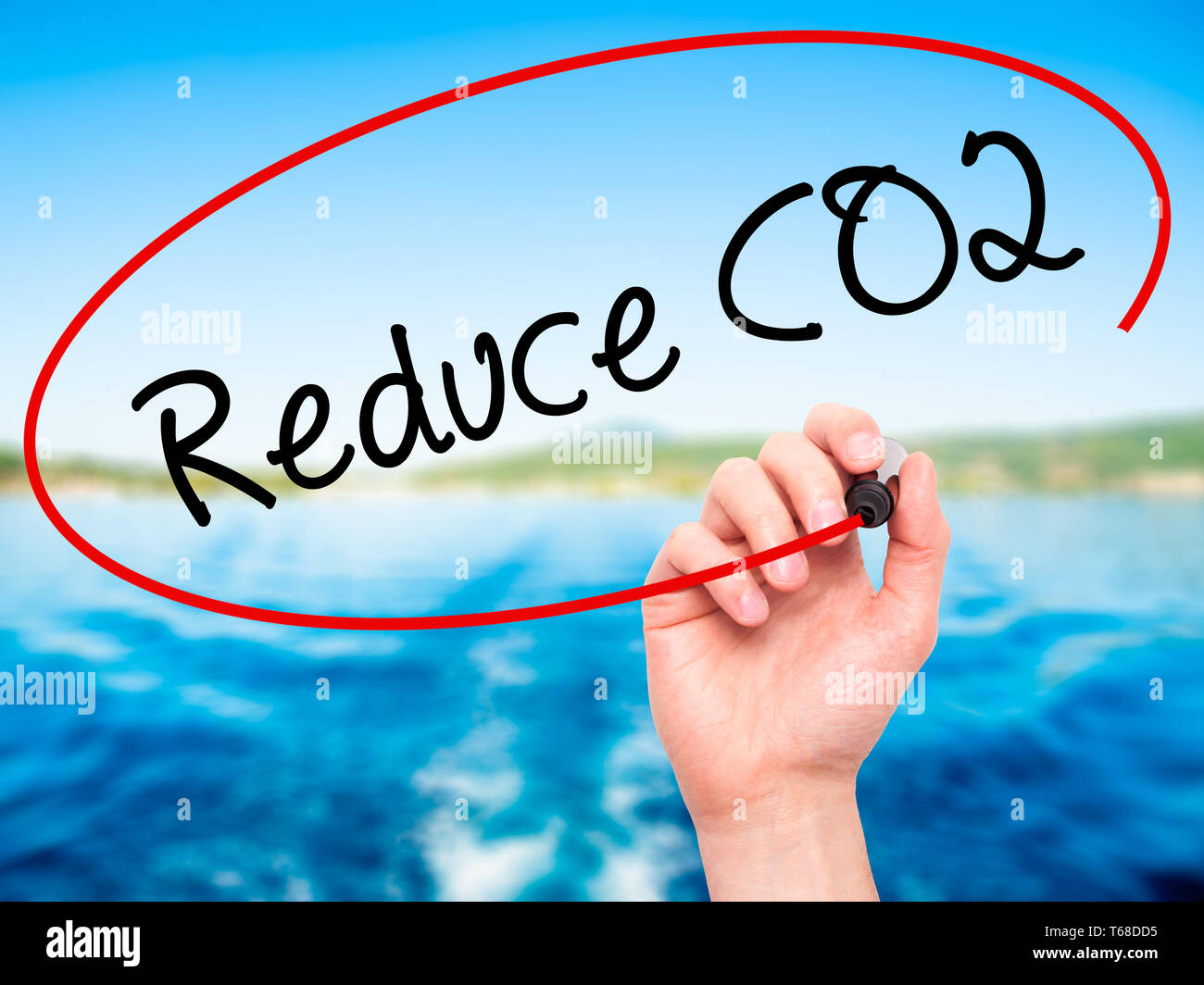 Man Hand writing Reduce CO2 with black marker on visual screen Stock ...