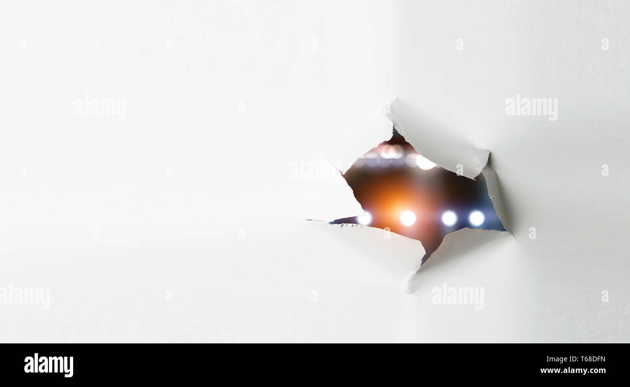 Paper torn hole effect with stadium view Stock Photo - Alamy
