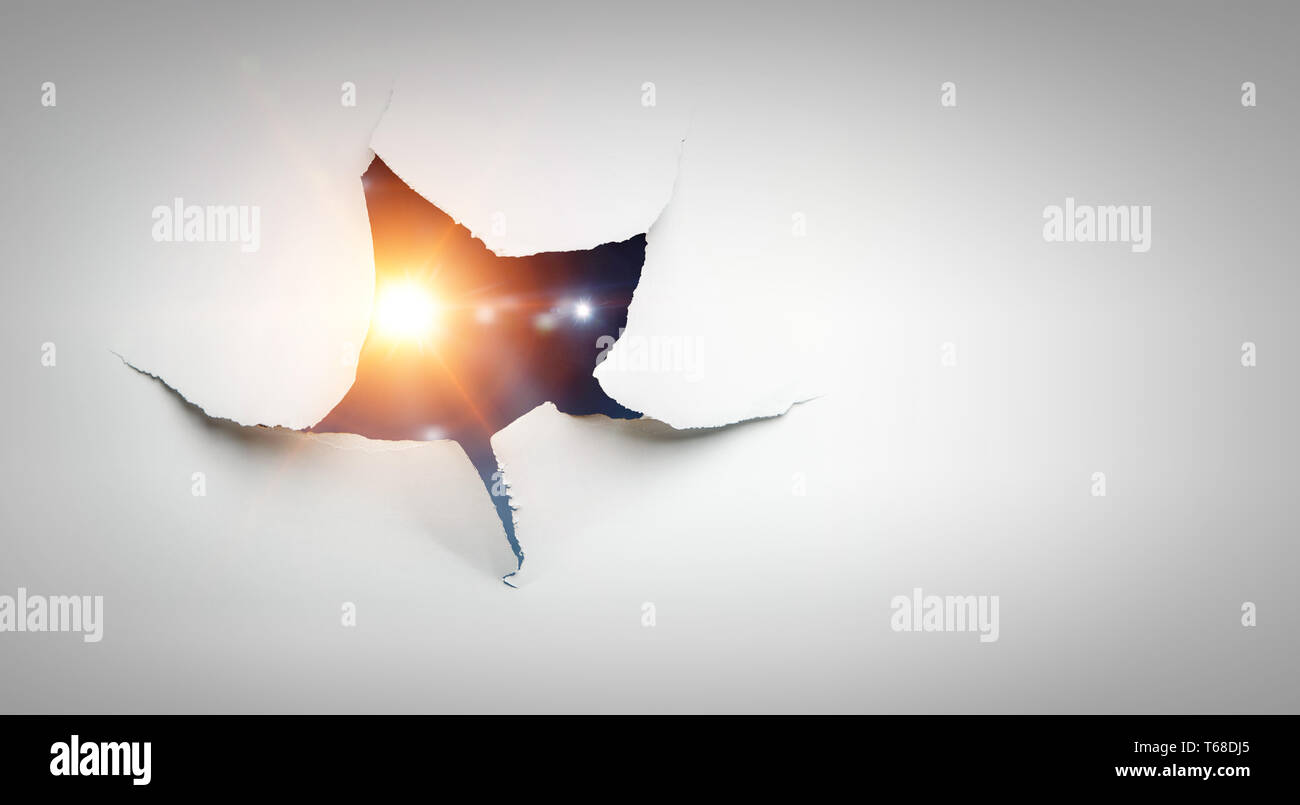 Paper torn hole effect with stadium view Stock Photo - Alamy